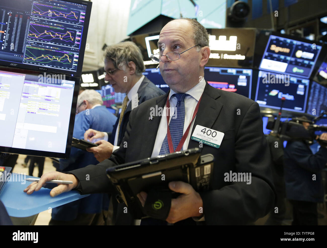 Traders work on the floor of the NYSE at the opening bell at the New ...