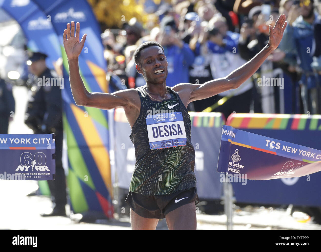 Lelisa Desisa Of Ethiopia celebrates after crossing the finish line and ...