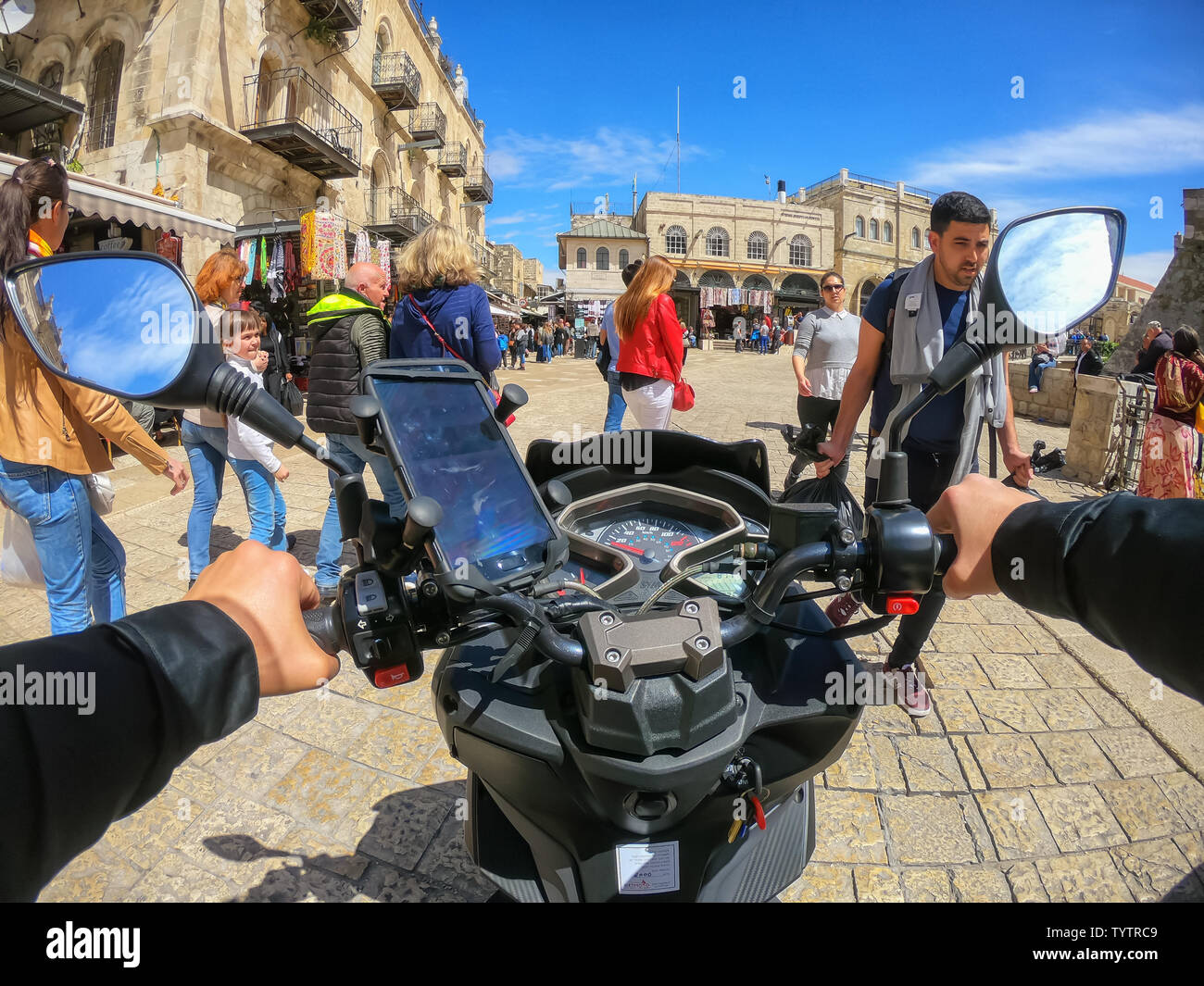 Jerusalem, Israel - April 16, 2019: Riding a scooter in the busy urban ...