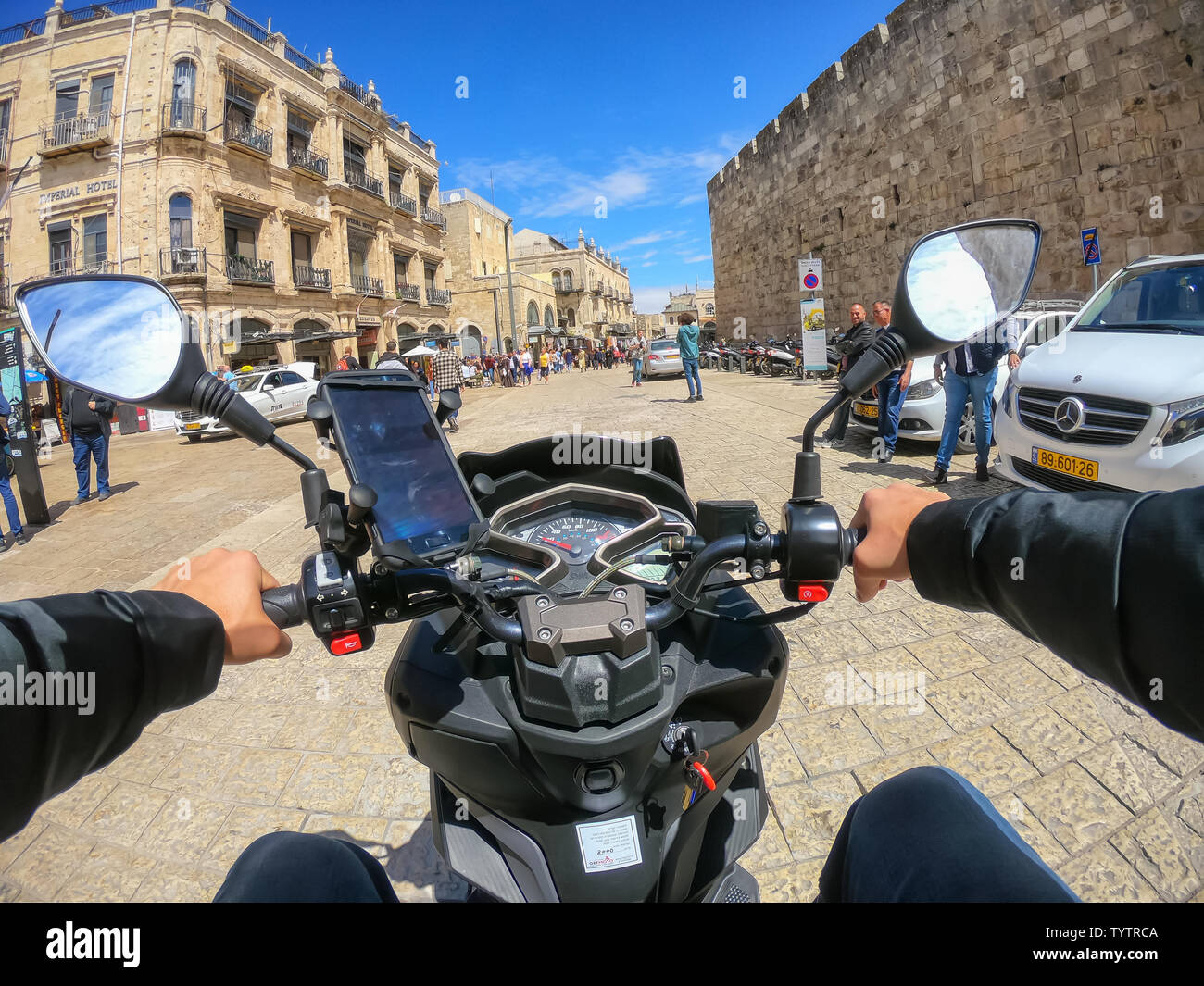 Jerusalem, Israel - April 16, 2019: Riding a scooter in the busy urban ...
