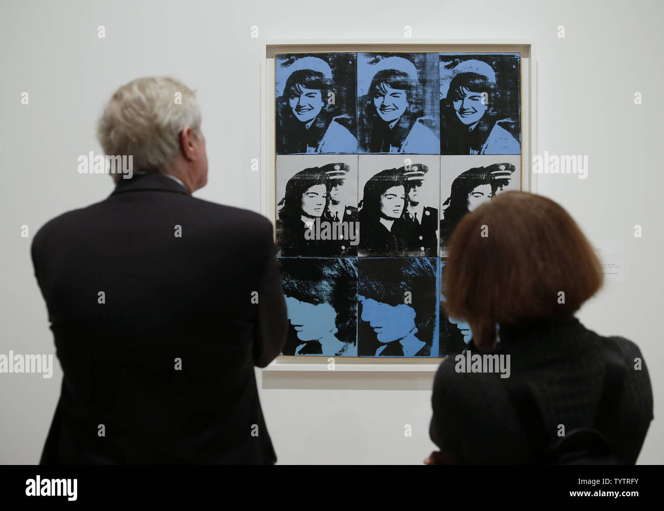 People stand among works of art by Andy Warhol at a member preview for the upcoming exhibit ...