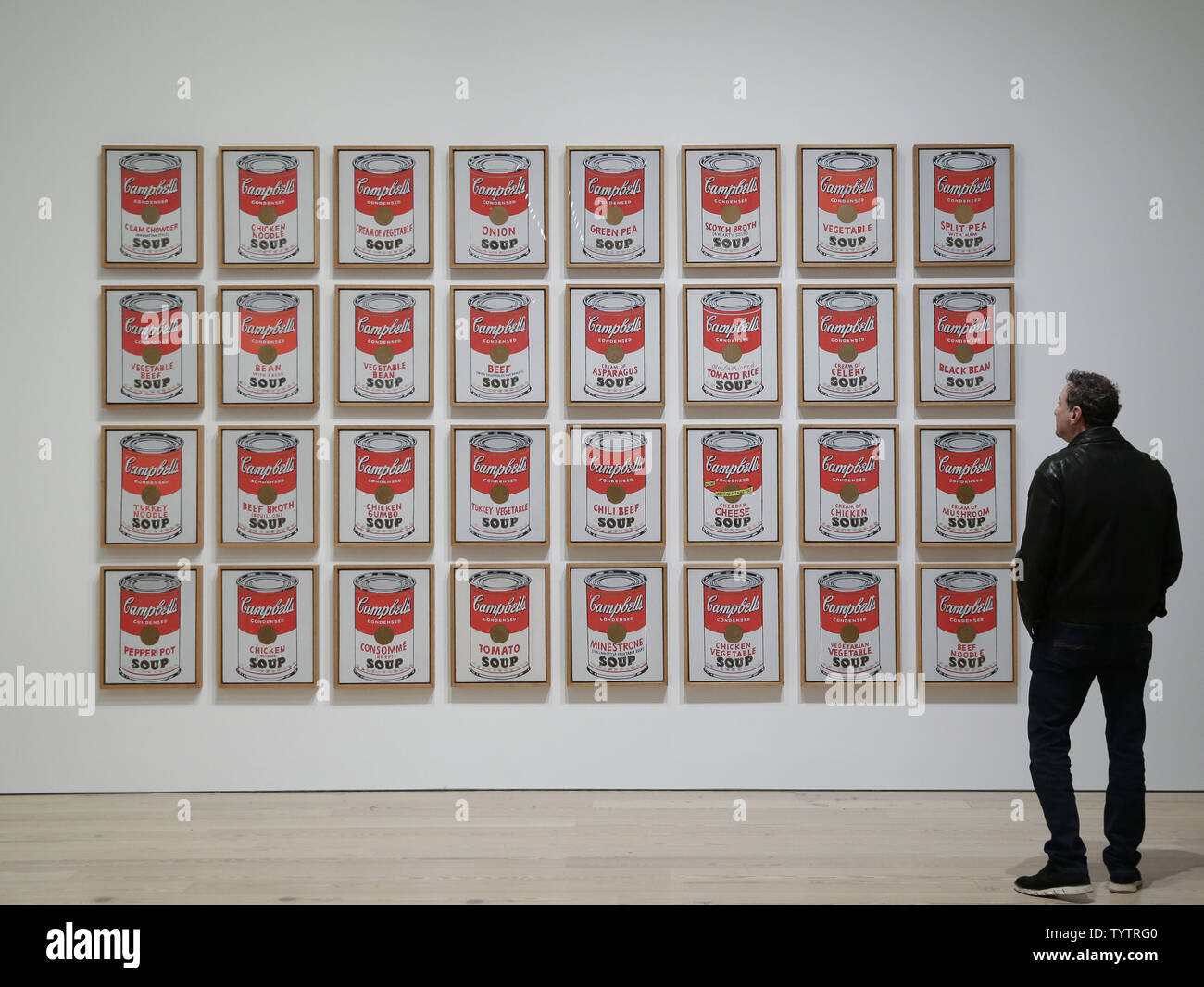 People stand among works of art by Andy Warhol at a member preview for the upcoming exhibit ...