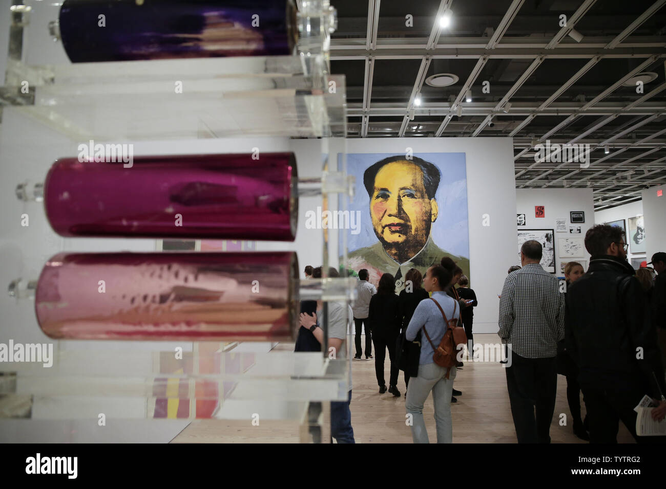 People stand among works of art by Andy Warhol at a member preview for the upcoming exhibit ...