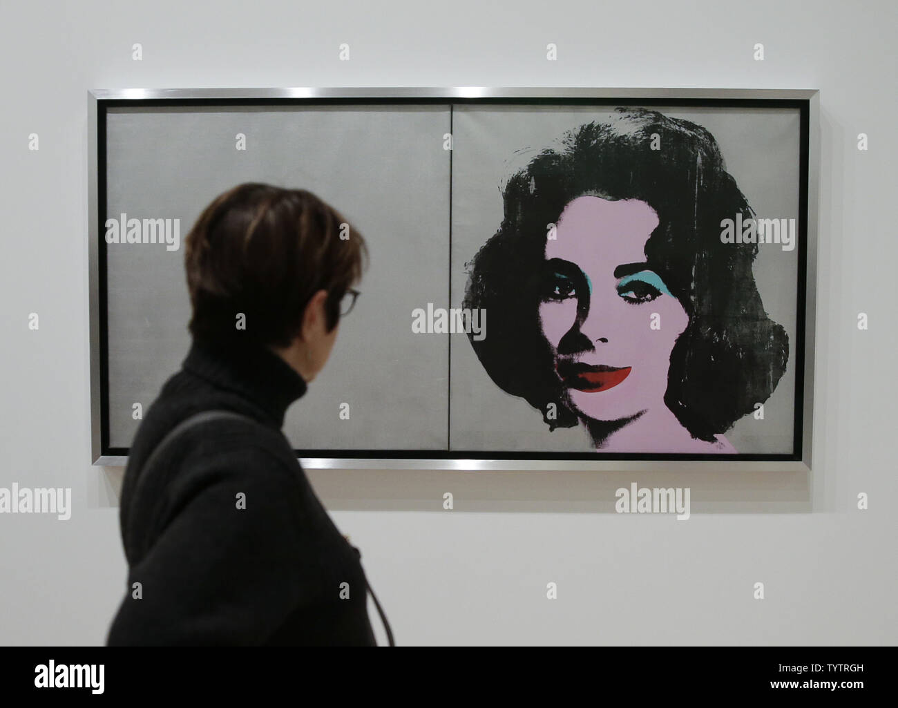People stand among works of art by Andy Warhol at a member preview for the upcoming exhibit ...