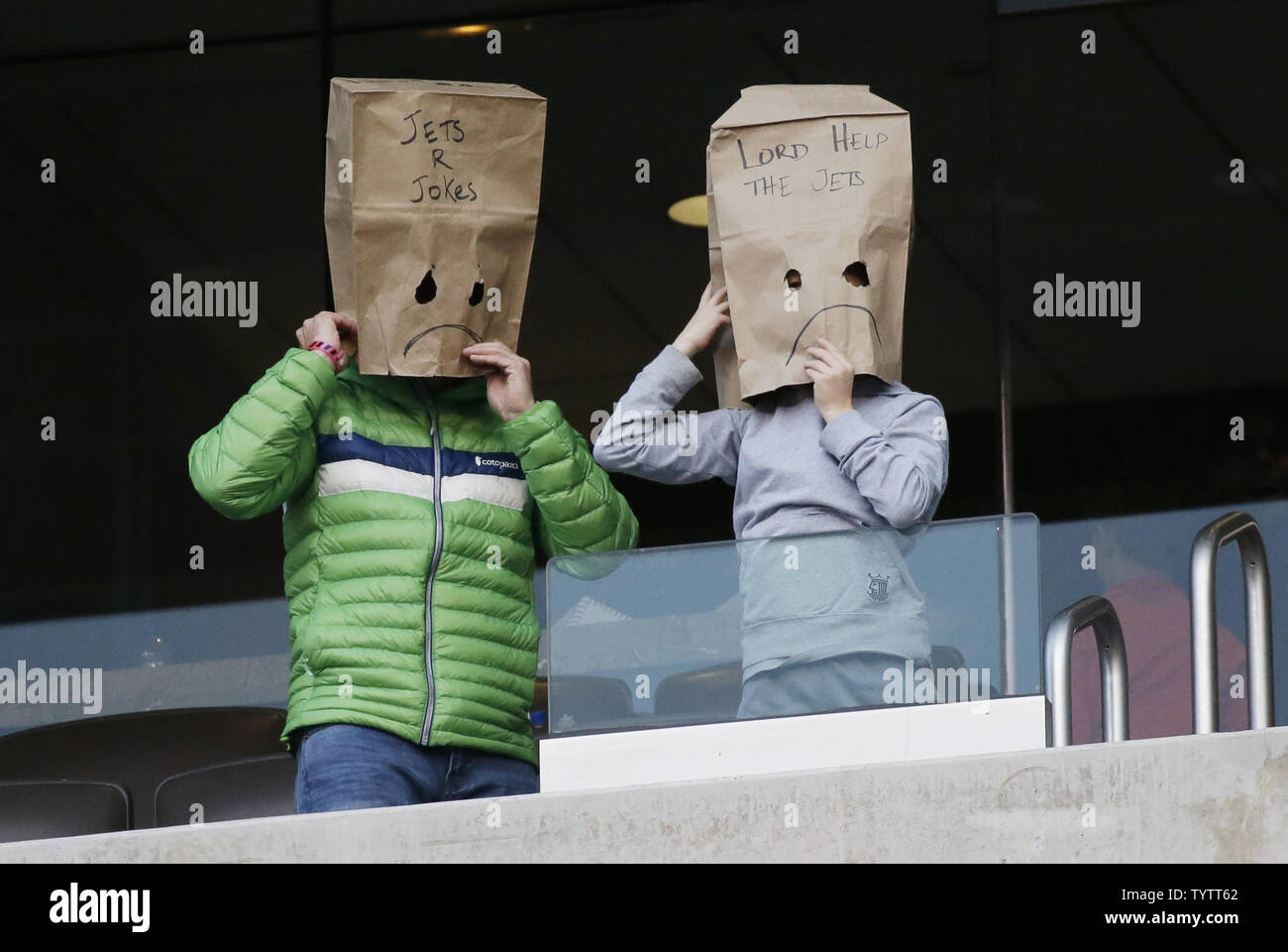 New York Jets fans hold paper bags on their heads in the 4th quarter ...