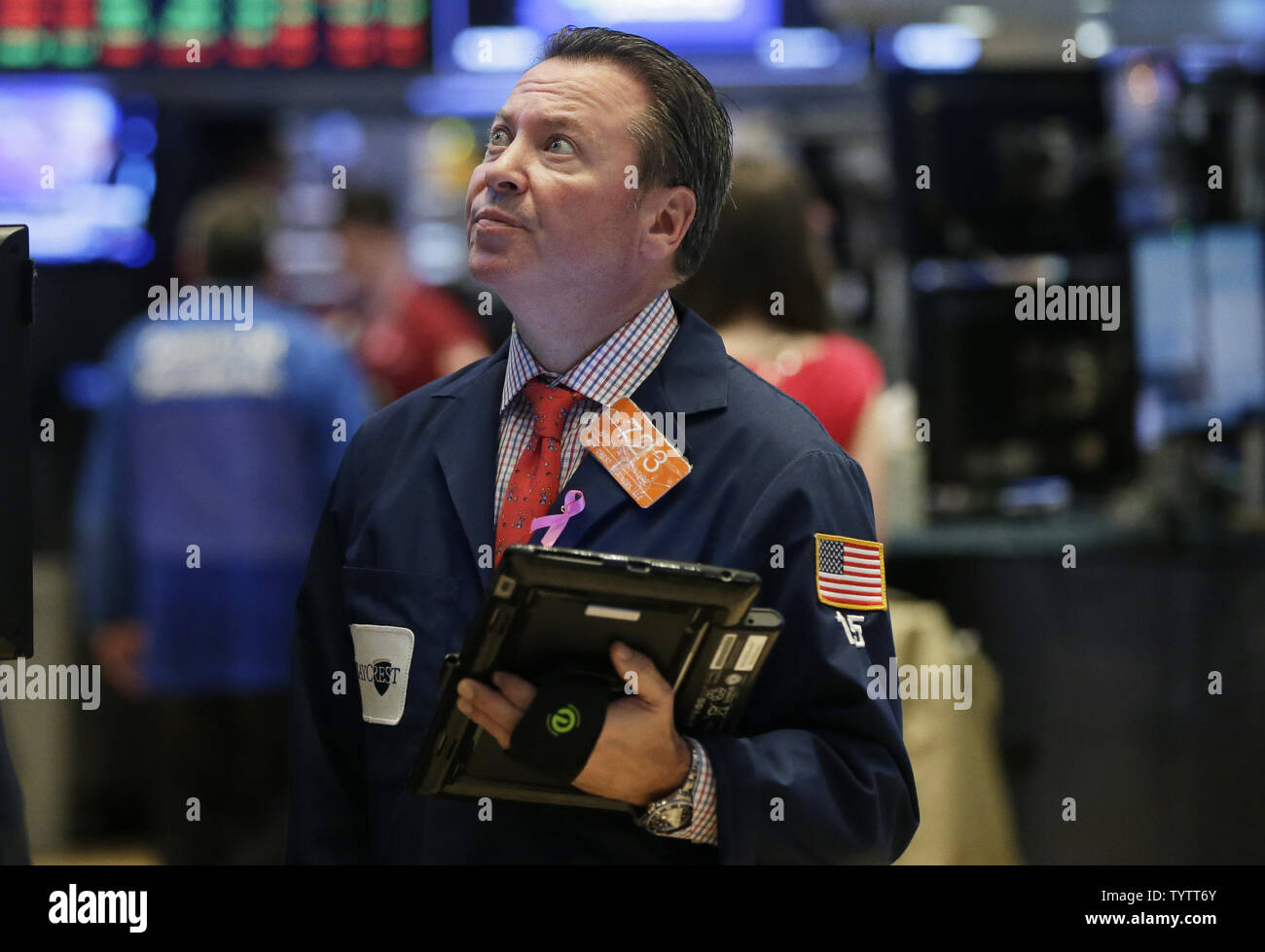 Traders work on the floor of the NYSE at the opening bell at the New ...