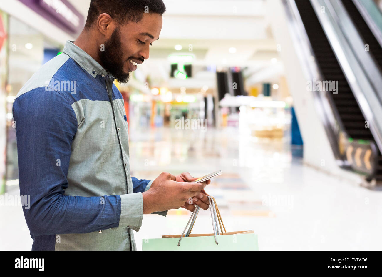 Smiling african american guy searching through the Internet Stock Photo ...