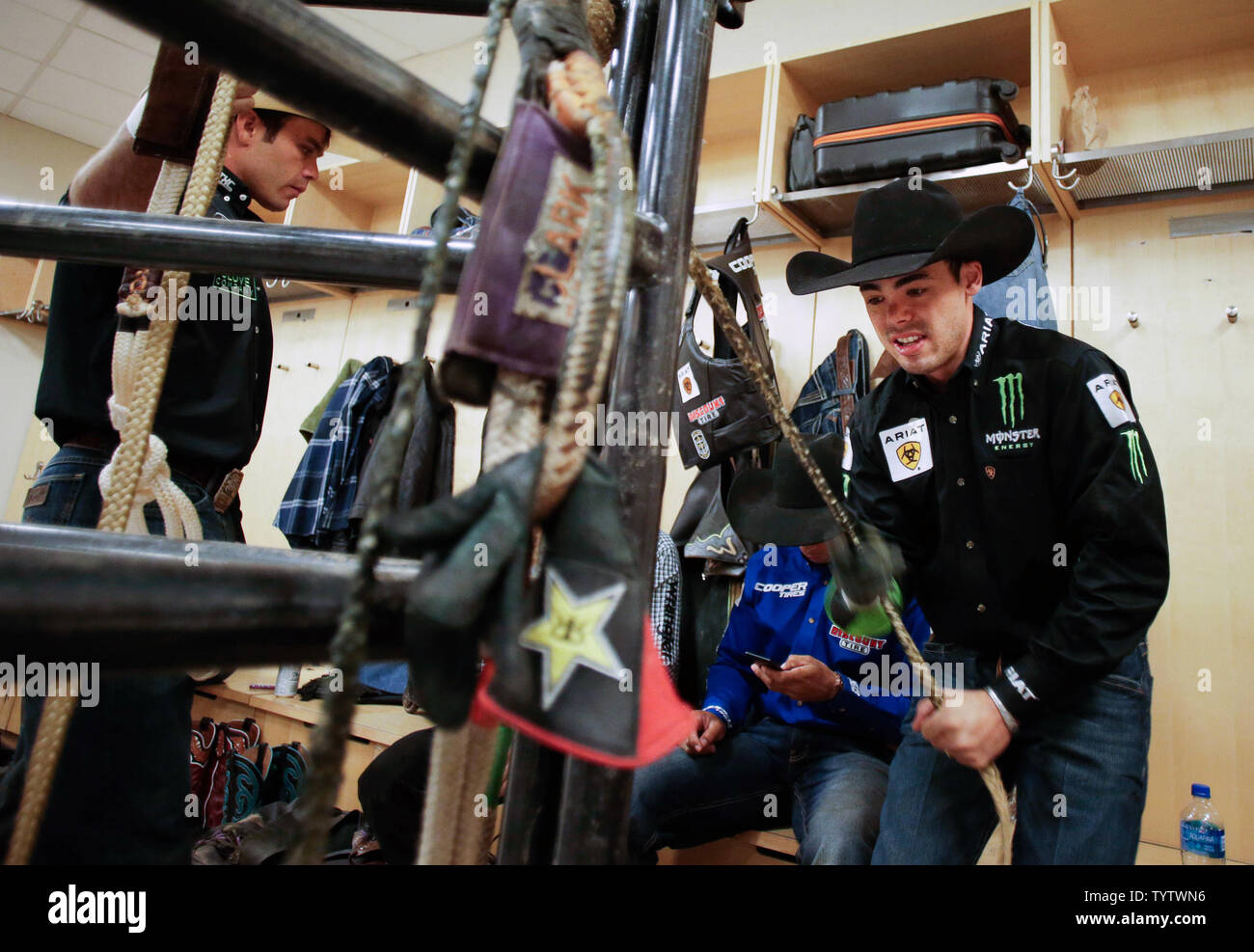 Competing bull riders get ready in the locker room at the Professional ...