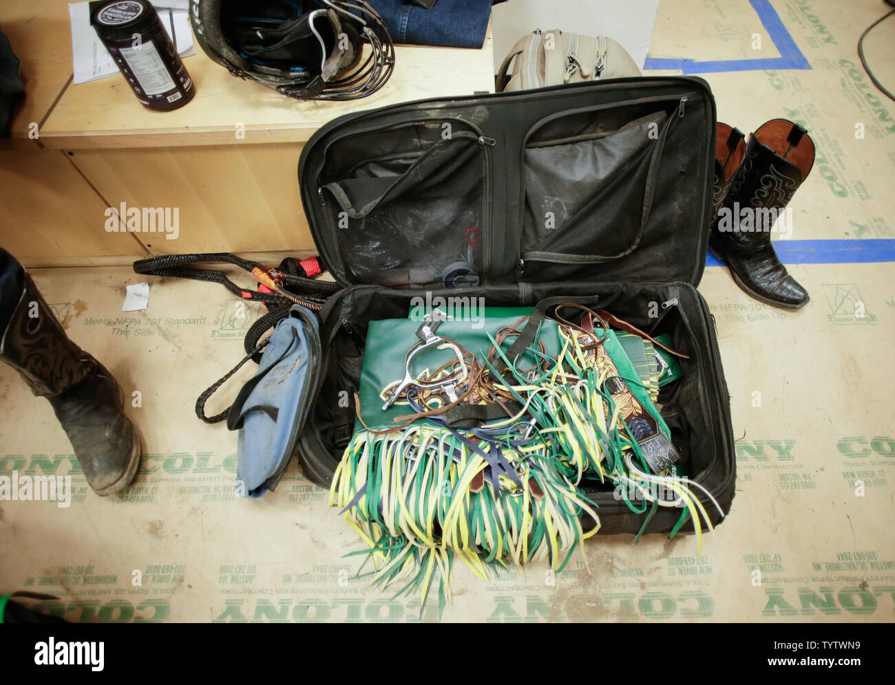 Competing bull riders get ready in the locker room at the Professional ...