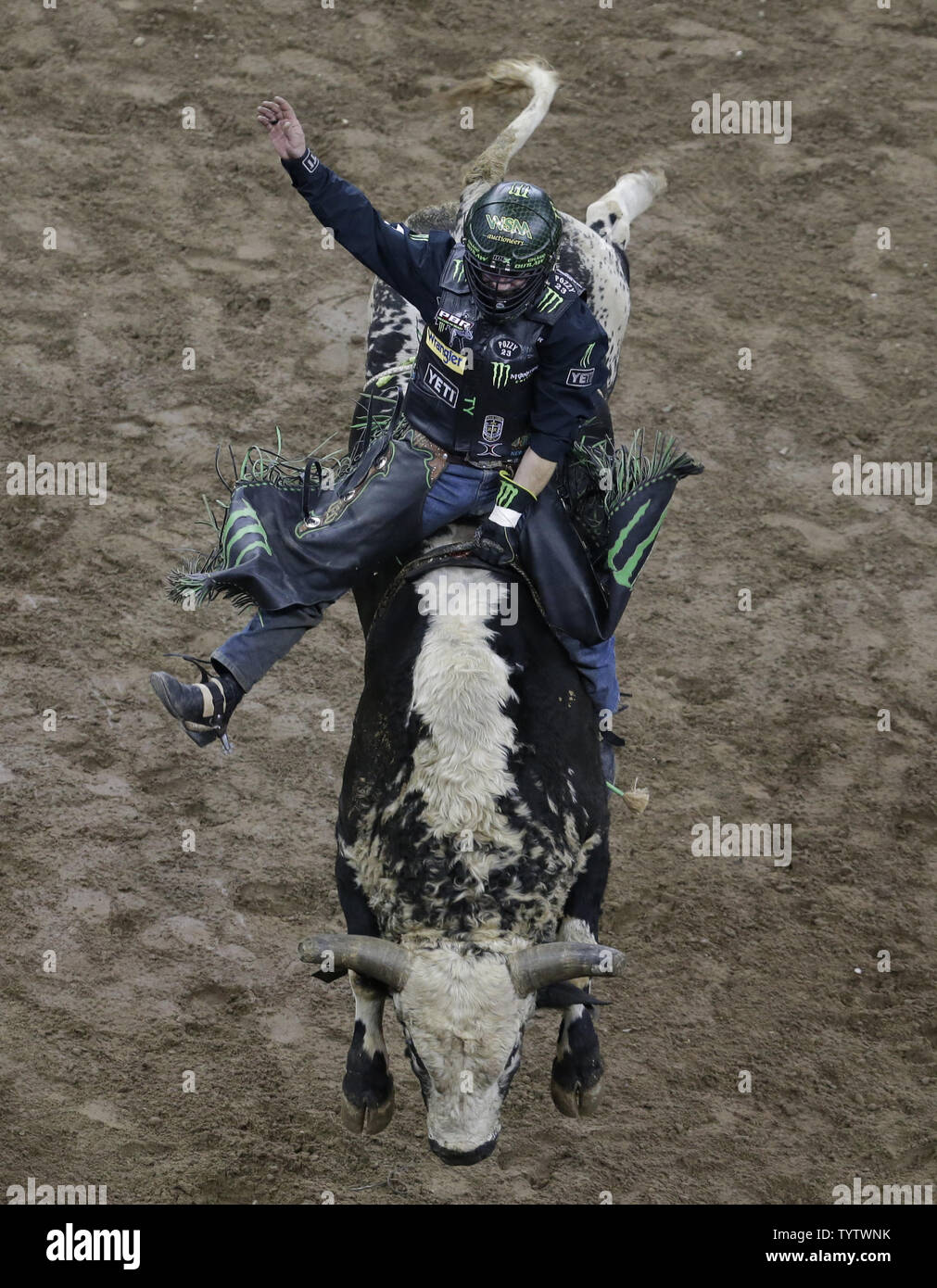 Bull riders compete in the championship round at the Professional Bull ...
