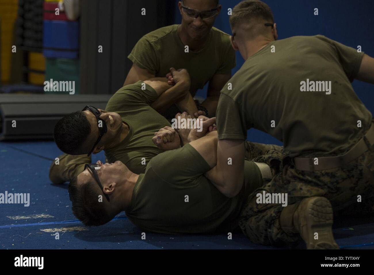 U.S. Marines with the Provost Marshal’s Office are tased to demonstrate ...