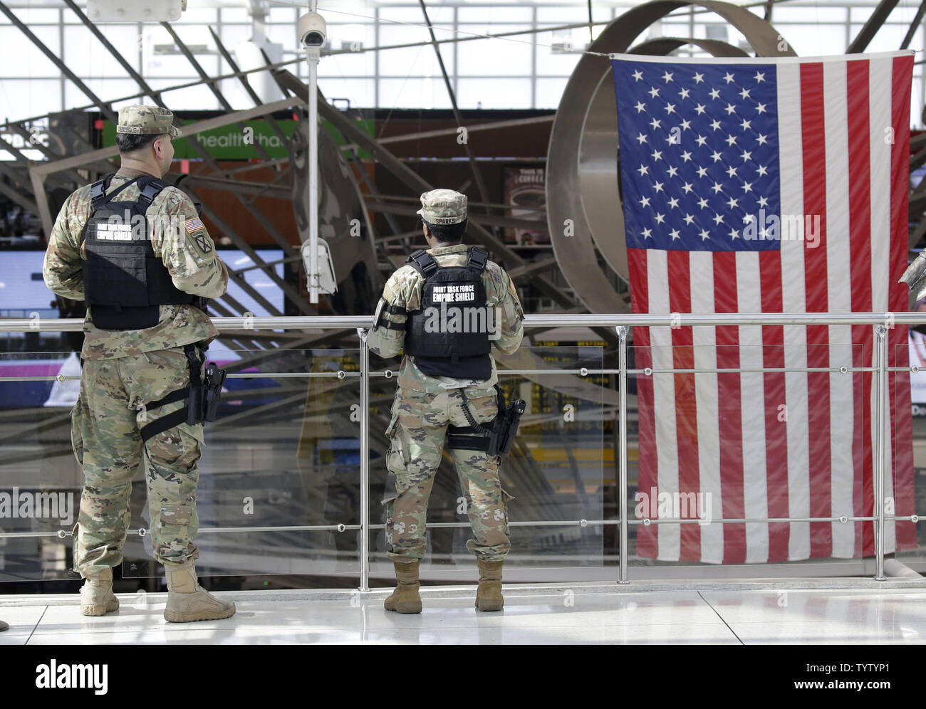 Armed security guards watch over travelers one day after the crash of ...