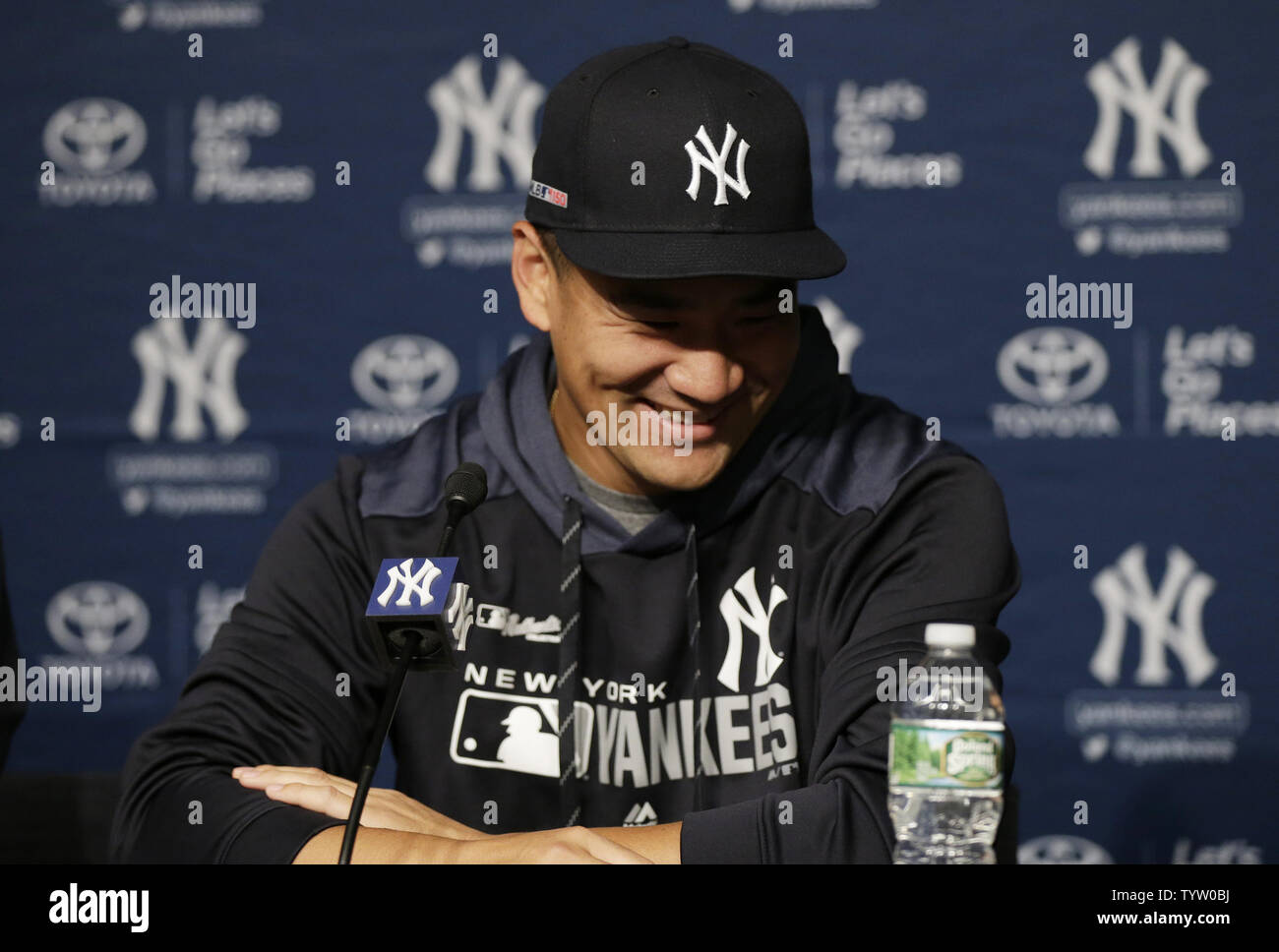 New York Yankees Opening Day starting pitcher Masahiro Tanaka smiles when he speaks at a press ...