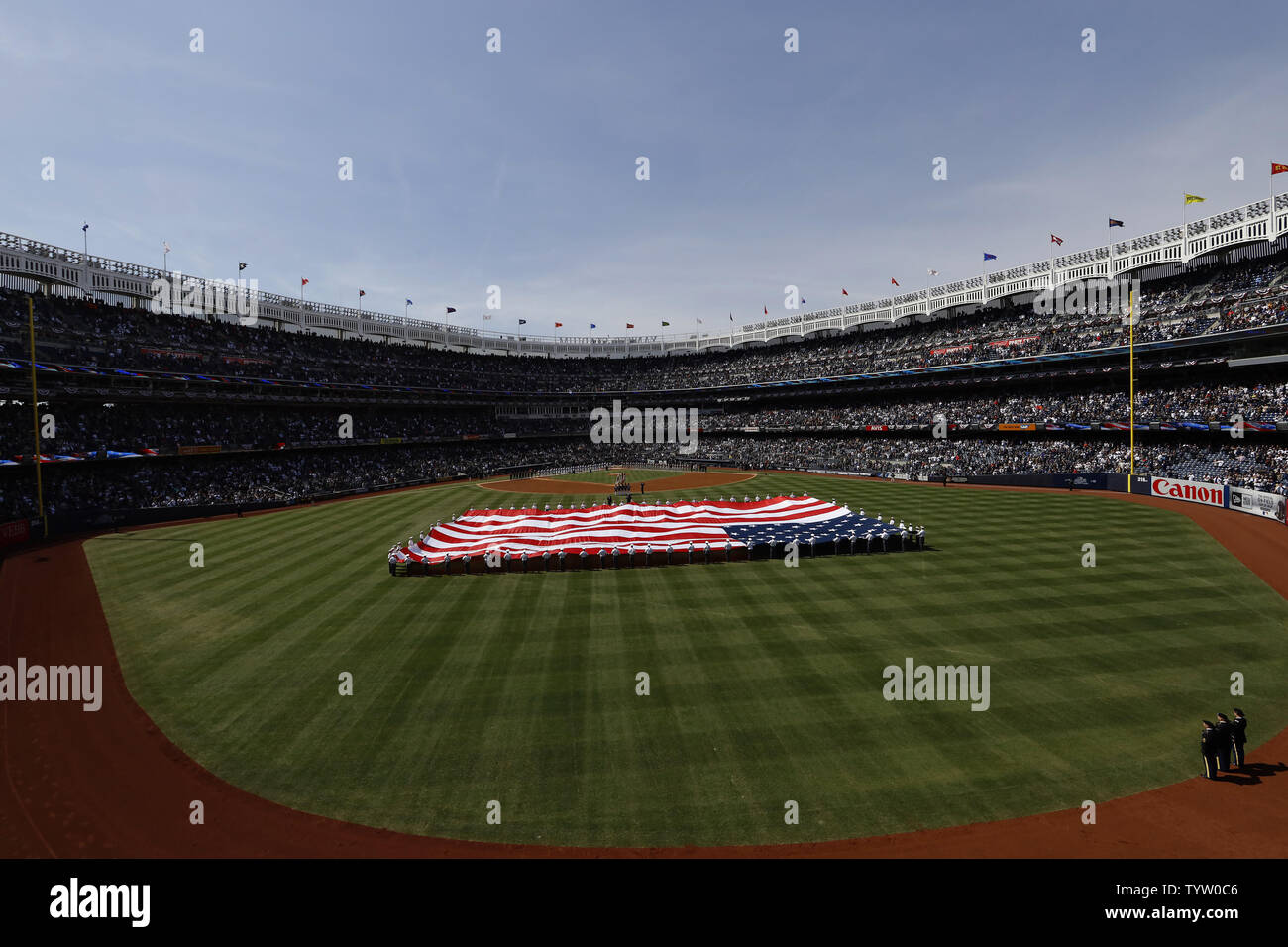 A giant American Flag is unfurled in center field for the National ...