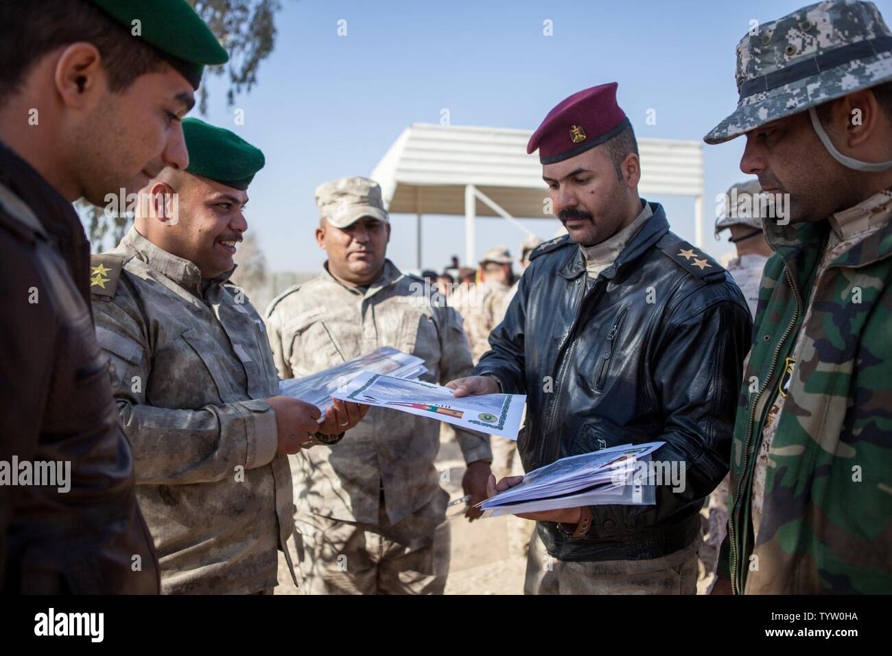 Iraqi security forces officers prepare certificates for the graduation ...