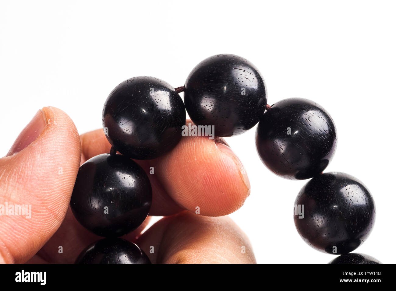 Hand string leaflet rosewood beads Stock Photo - Alamy