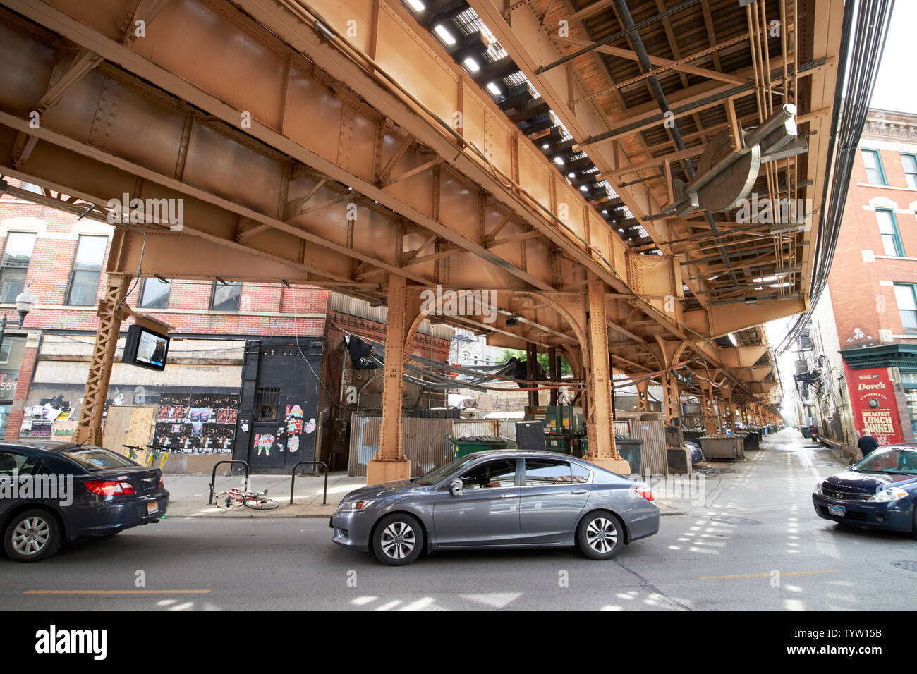 cars drive underneath the blue line L train station at Damen Chicago IL ...
