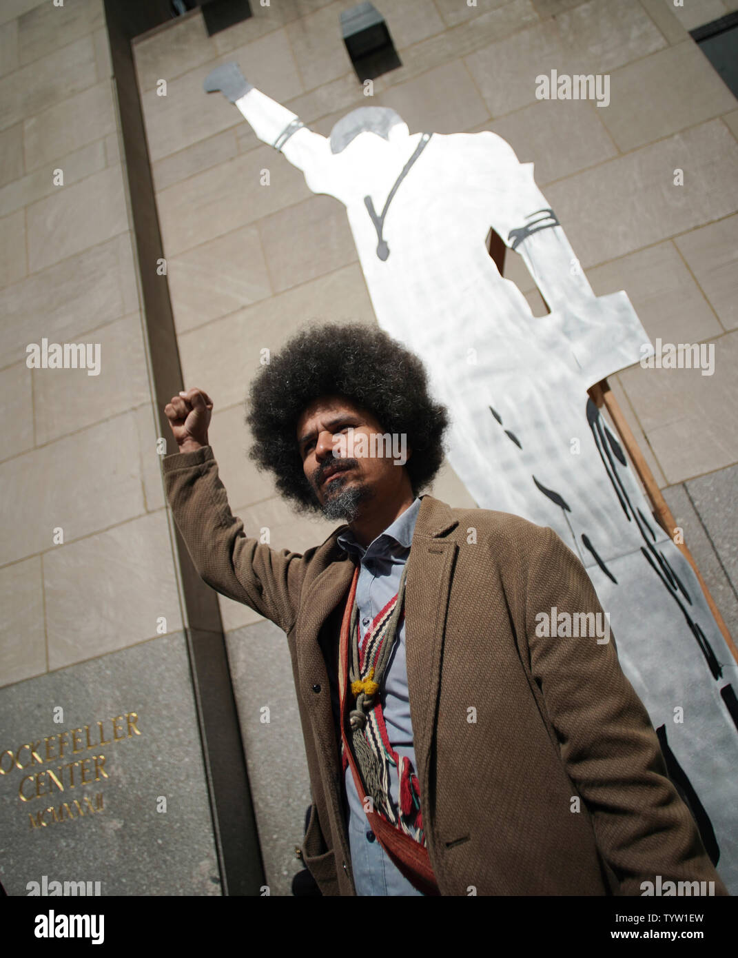 Artist Paulo Nazareth stands with DRY CUT [from BLACKS IN THE POOL ...