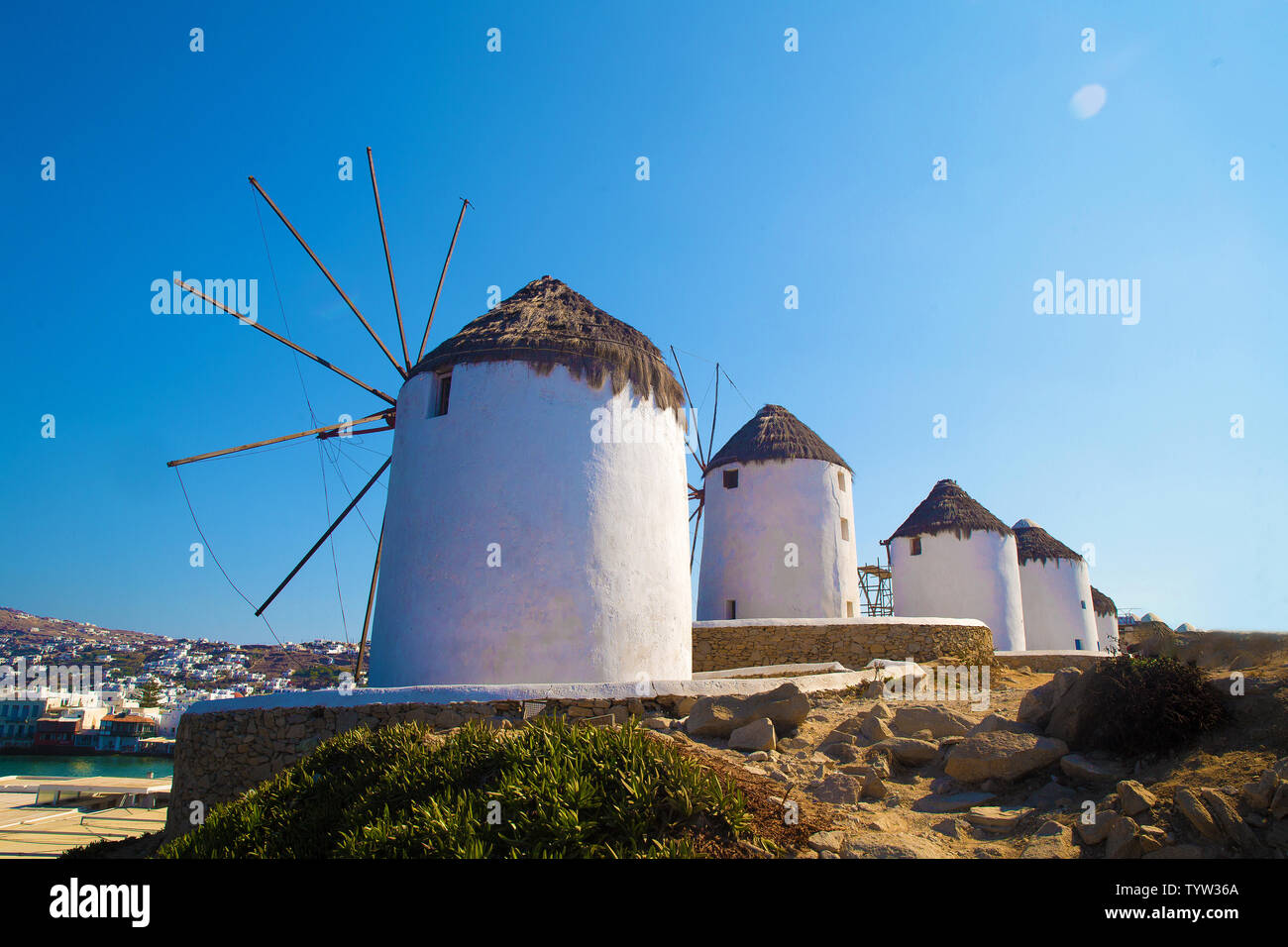 Famous mills on Mykonos island. and 2 persons (at far distance) making ...