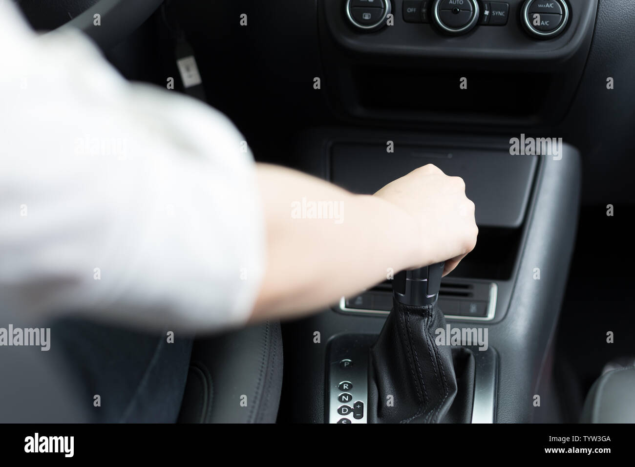 Hand holding gear in car Stock Photo - Alamy