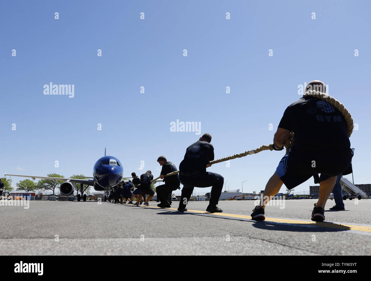 Teams pull an Airbus 320 aircraft when JetBlue Airlines hosts a Plane ...