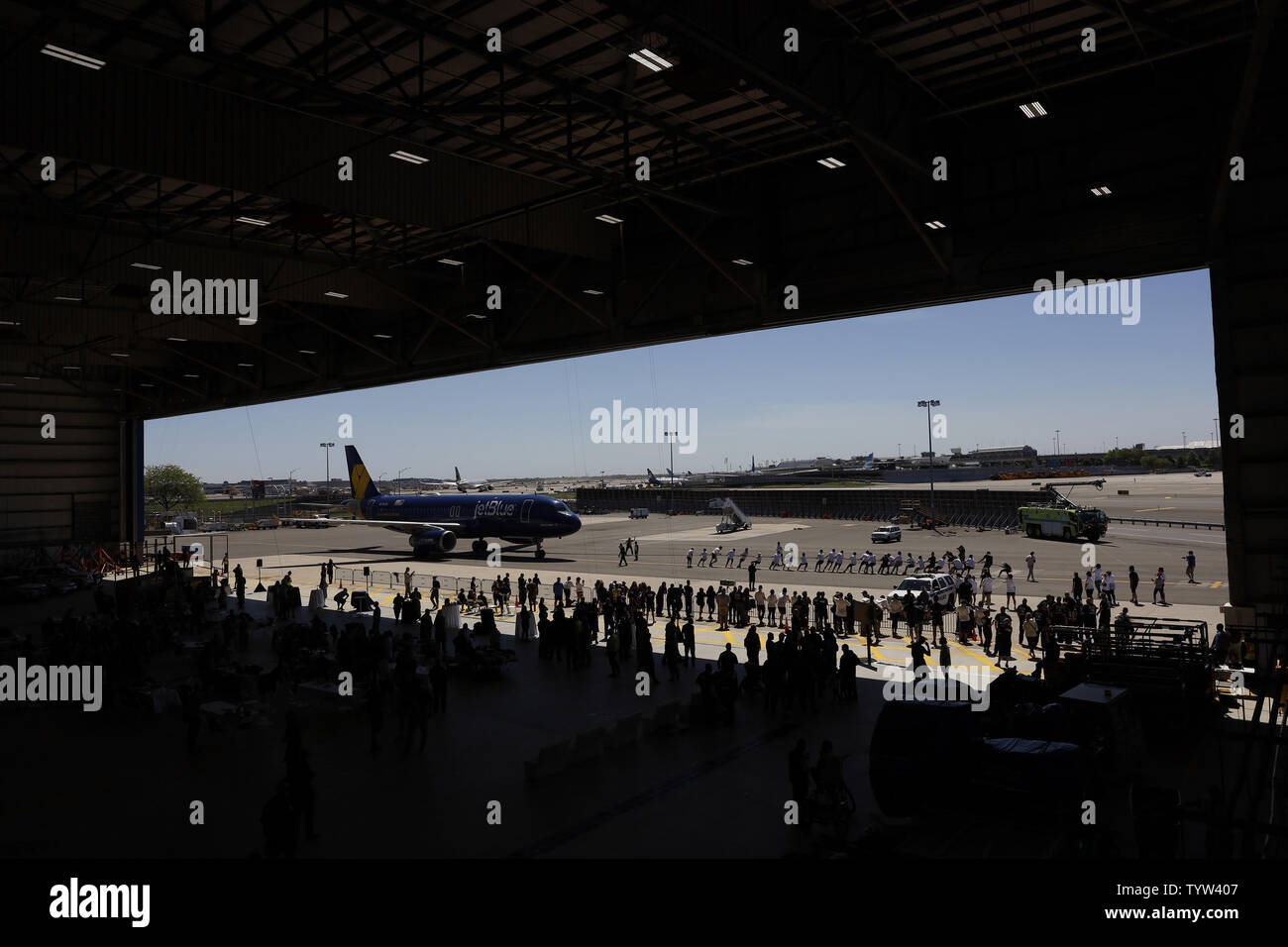 Teams pull an Airbus 320 aircraft when JetBlue Airlines hosts a Plane ...