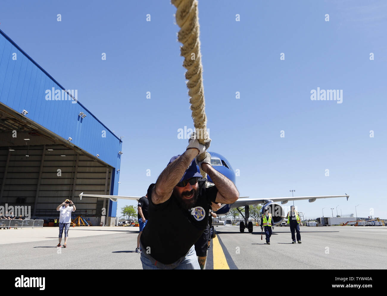 Teams pull an Airbus 320 aircraft when JetBlue Airlines hosts a Plane ...