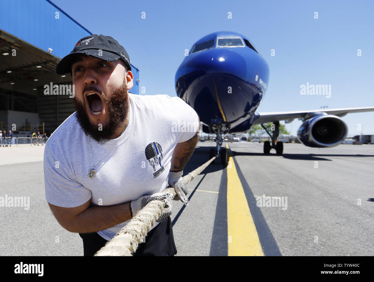 Teams pull an Airbus 320 aircraft when JetBlue Airlines hosts a Plane ...