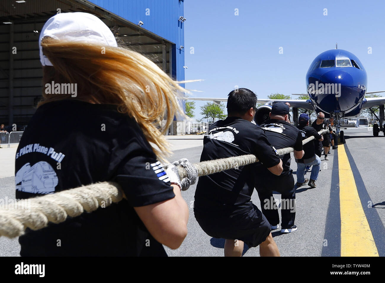 Teams pull an Airbus 320 aircraft when JetBlue Airlines hosts a Plane ...