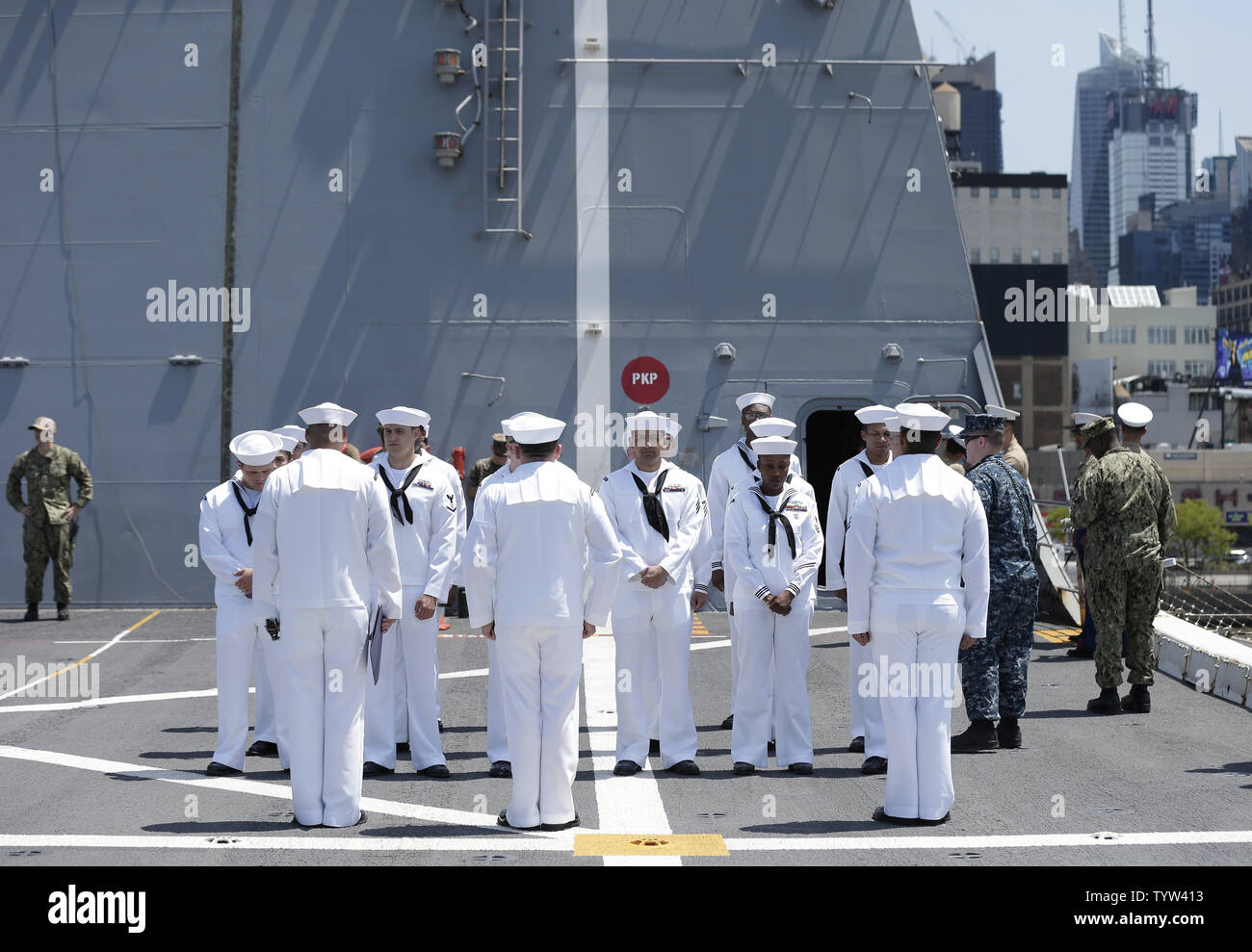 United States Navy personnel stand on the deck when the New York ...
