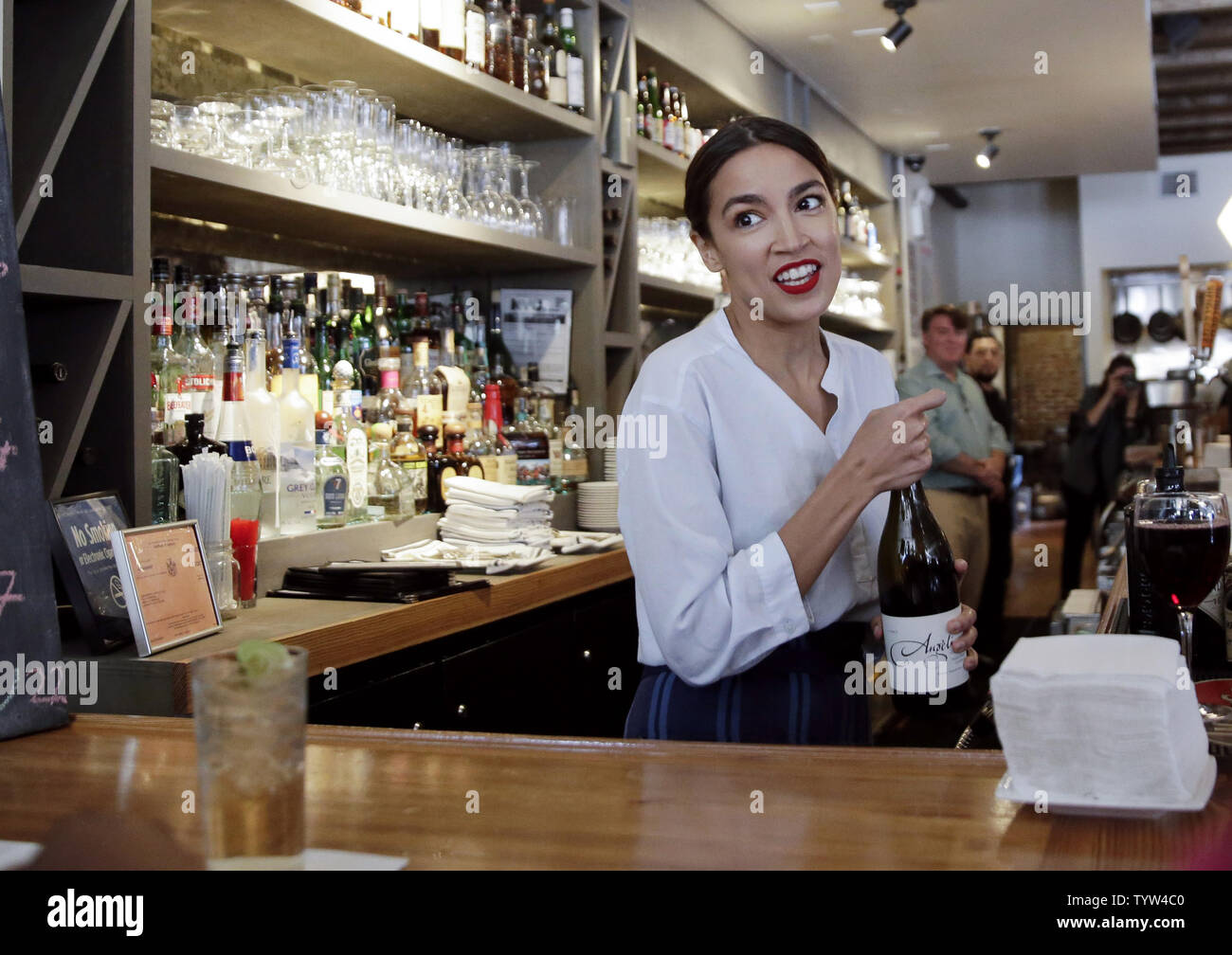 U.S. Representative Alexandria Ocasio-Cortez bartends and waits on ...