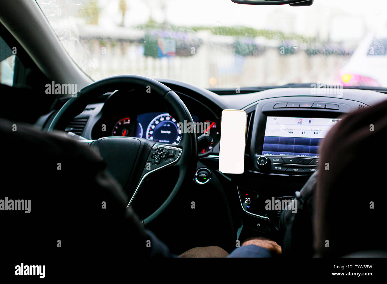 Inside view of the car and mobile phone by the steering wheel, copy ...