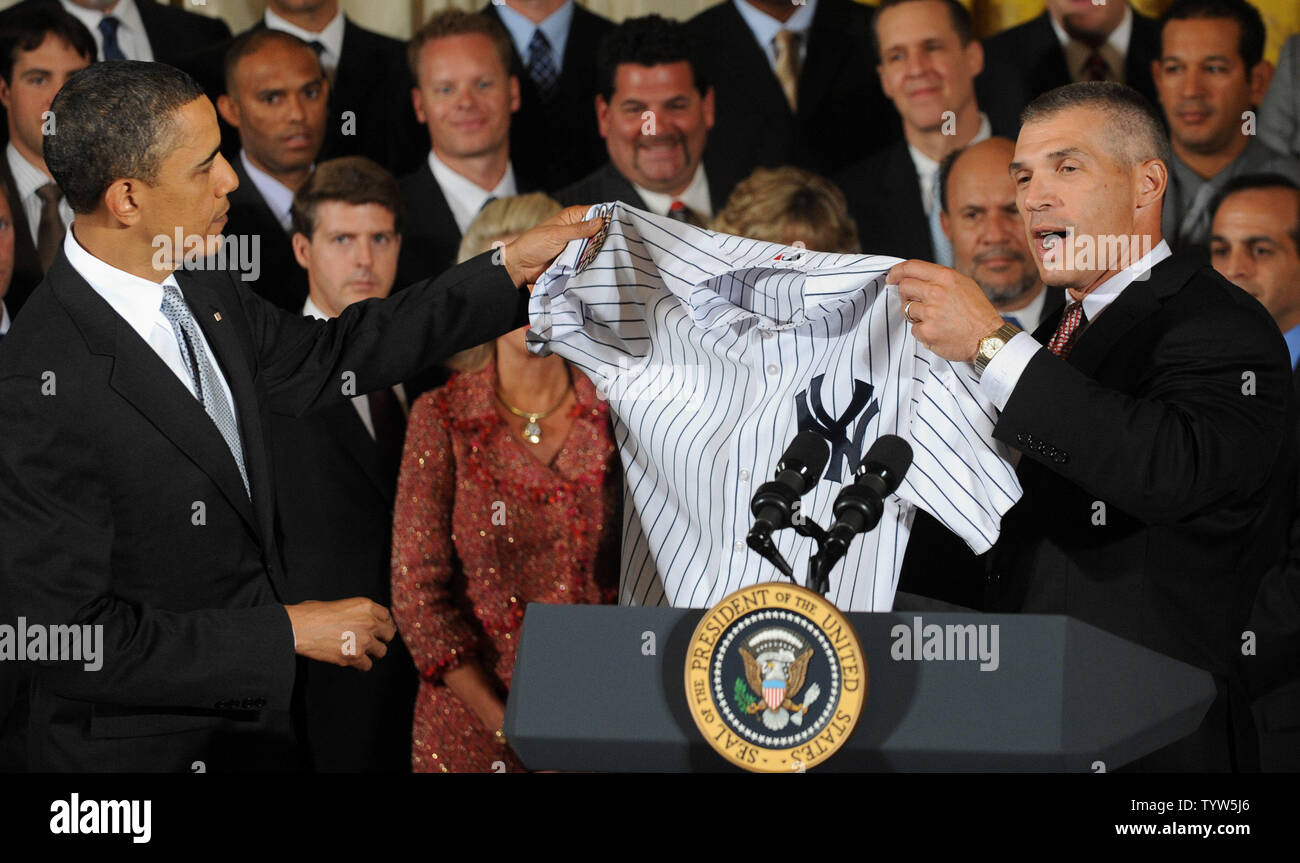 U.S. President Barack Obama accepts a team jersey from Yankees Manager ...