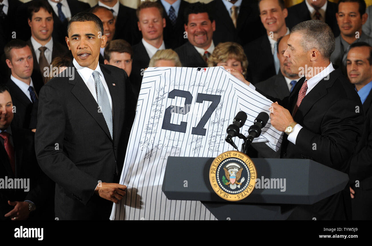 U.S. President Barack Obama accepts a team jersey from Yankees Manager ...