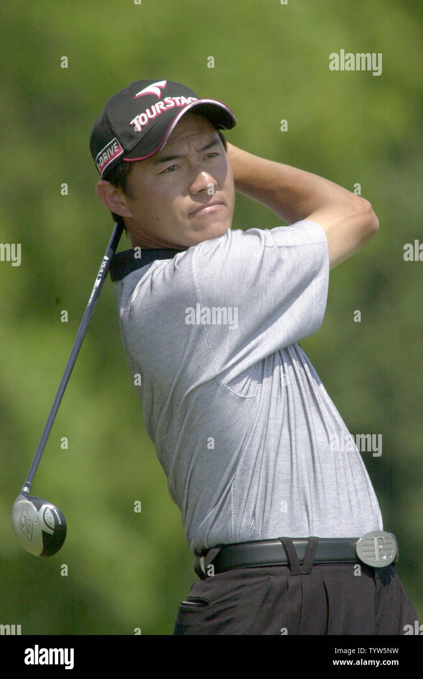 Toru Taniguchi of Japan watches the flight of his drive at the 11th tee ...