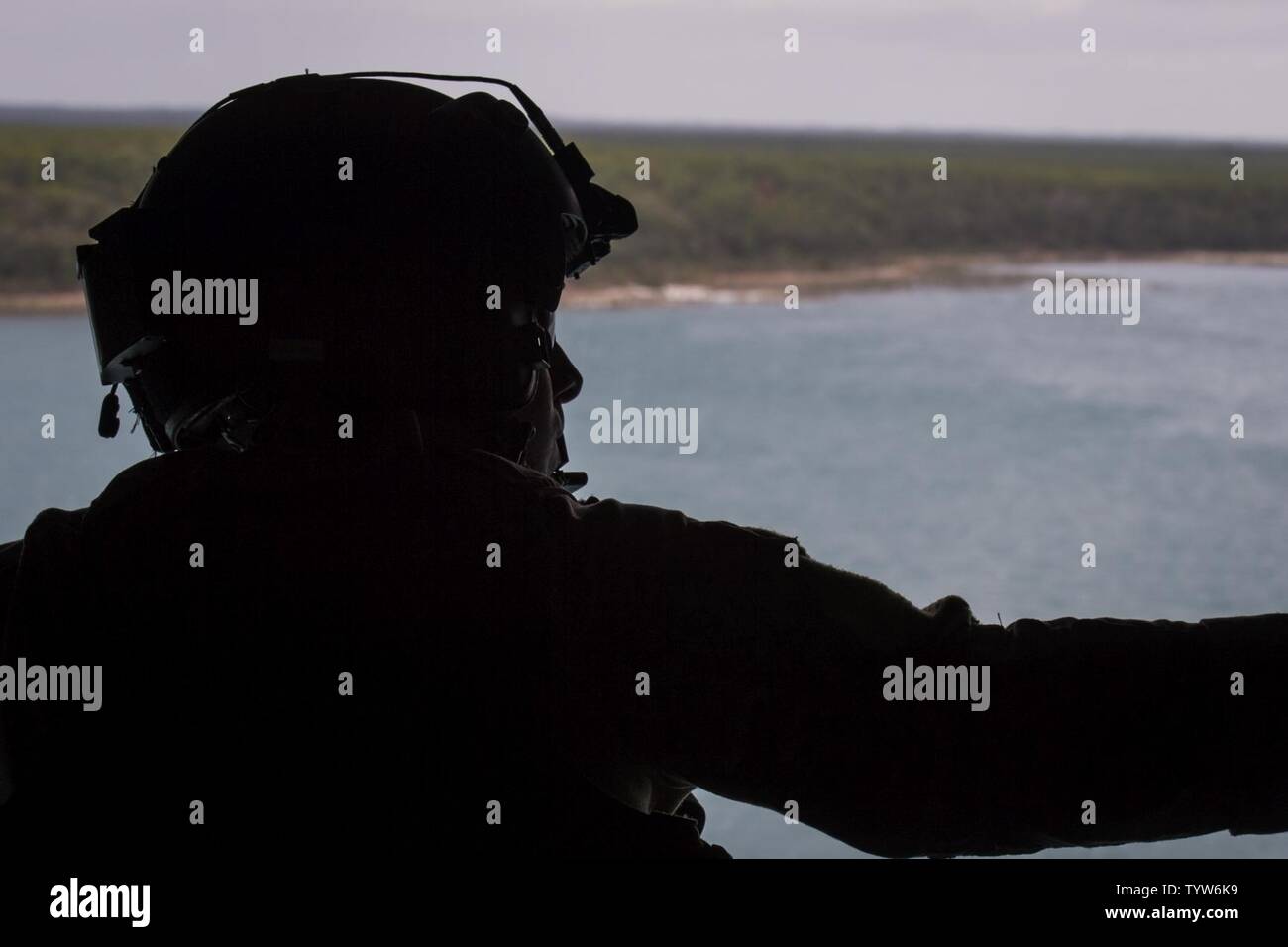 A flight engineer with the 8th Special Operations Squadron looks out at ...