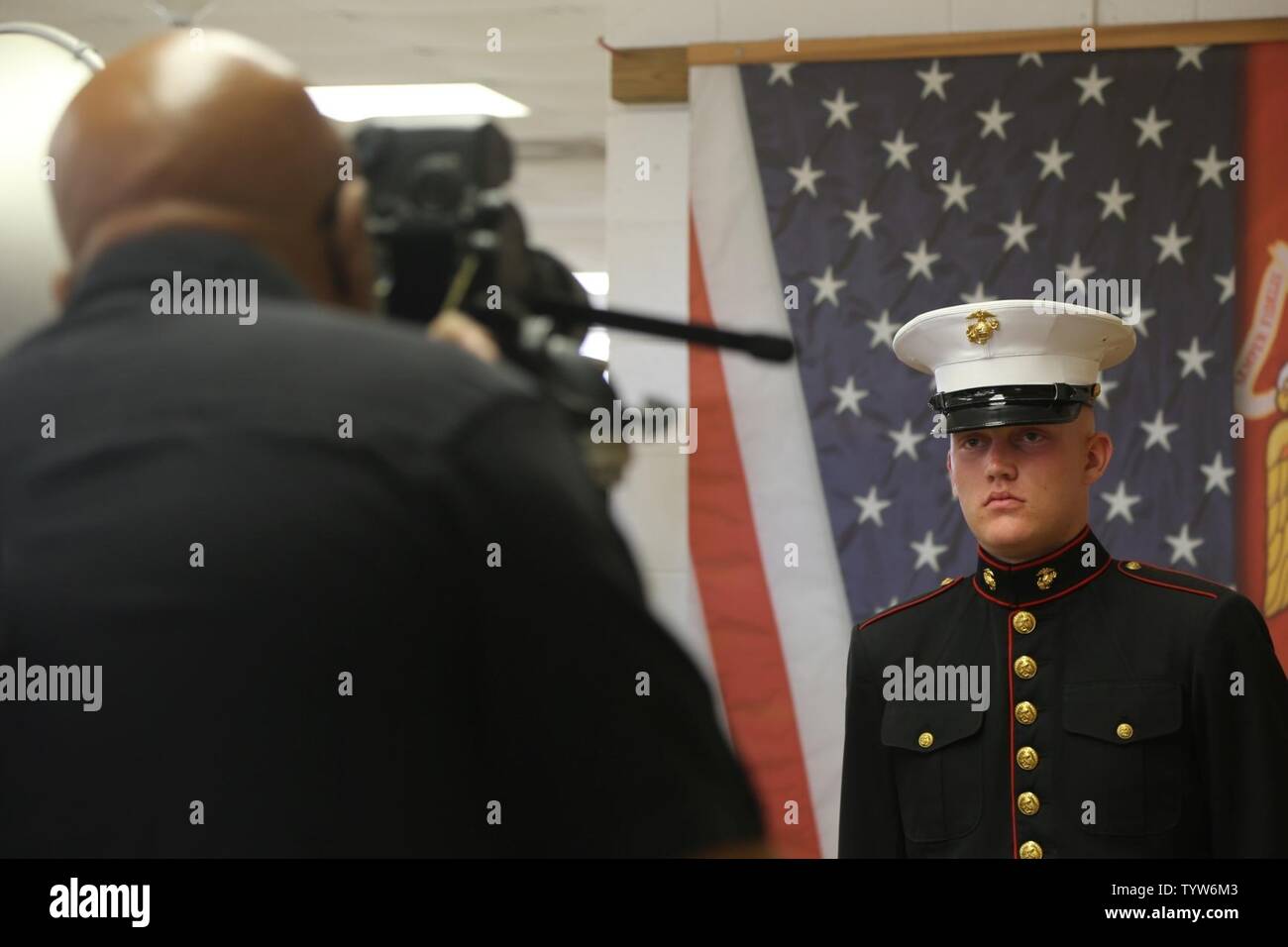 Christopher Deans, a Recruit Photographer, takes an official photo of a ...