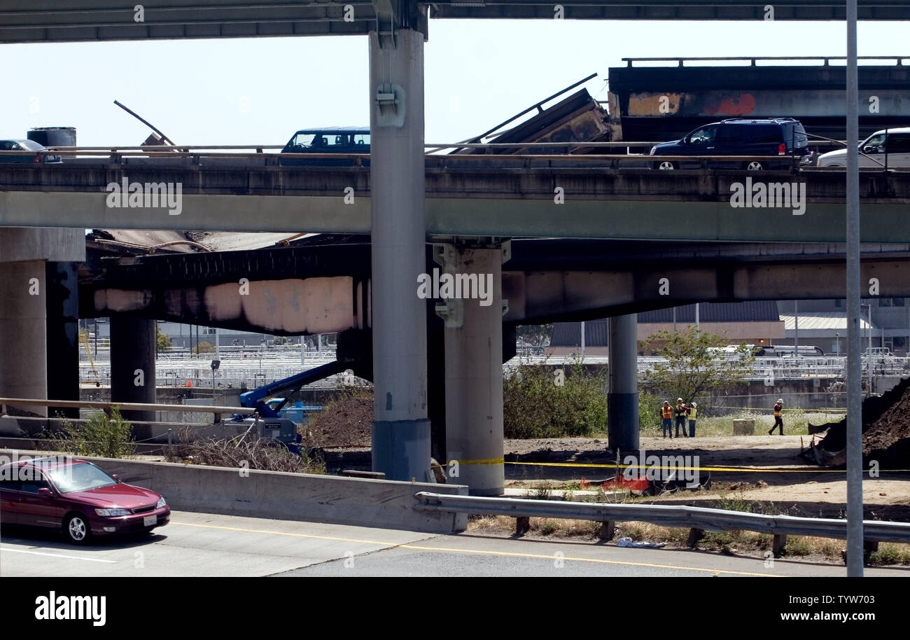 Traffic makes its way past a section of collapsed highway near the San ...
