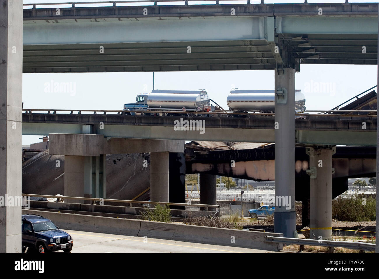 Traffic makes its way past a section of collapsed highway near the San ...