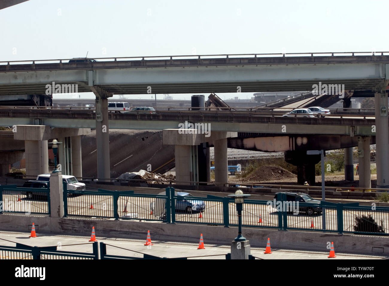 Traffic makes its way past a section of collapsed highway near the San ...
