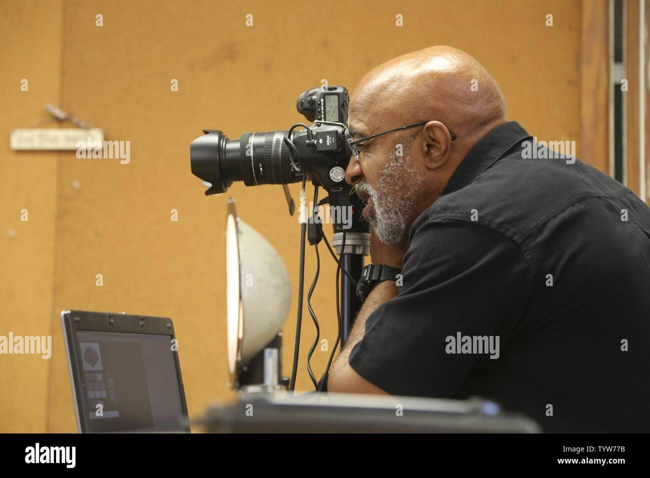 Christopher Deans, a Recruit Photographer, takes an official photo of a ...