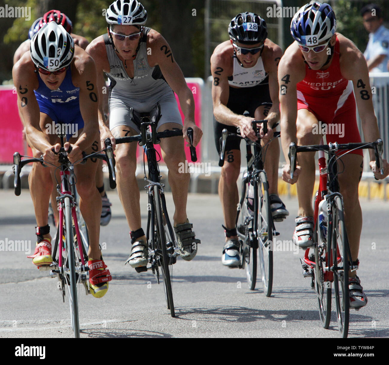 The lead pack of the men's Olympic triathlon race, from left: Frederic ...