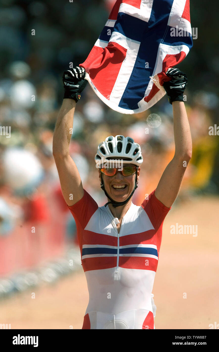 Gunn-Rita Dahle of Norway celebrates as she crosses the finish line to ...