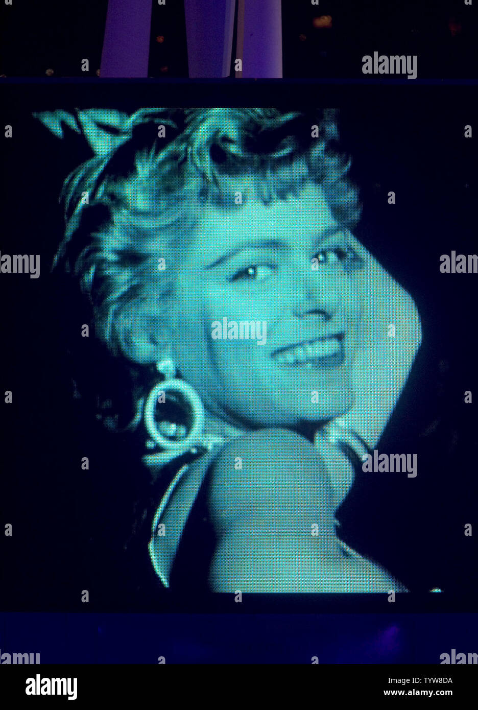 Singers and performers are shown on jumBo screens at the closing ...