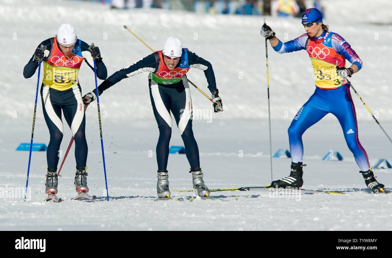 Carl van Loan of the USA tags team mate Bill Demong (L) while Russia's ...
