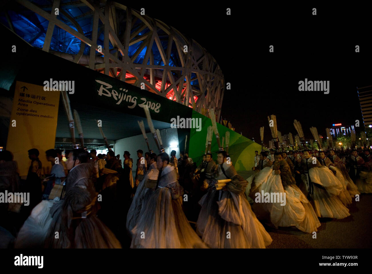 Members of the cast hustle off during a set change at the National ...