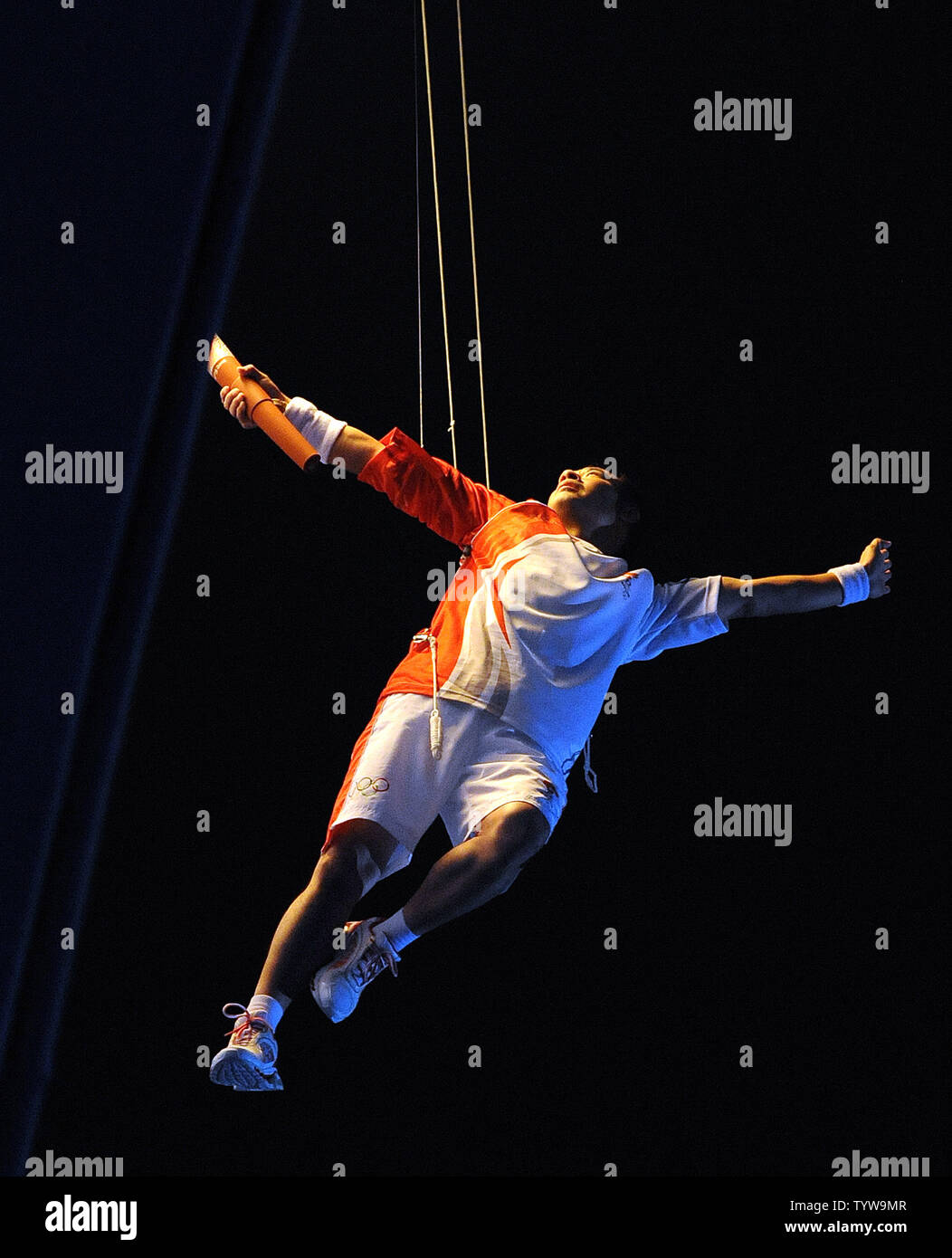 Artistic gymnast Li Ning lights the Olympic Cauldron on top of the ...