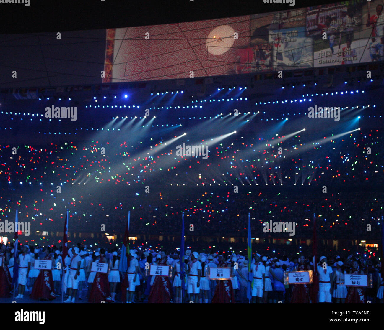 Former Gold Medalist Li Ning carries the Olympic Torch around the top ...