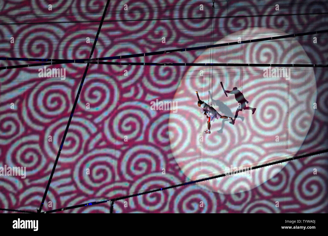 China's gold medal-winning gymnast Li Ning, glides through the air as ...