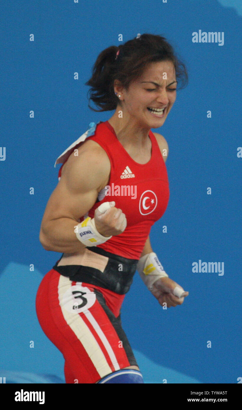 Turkish 48kg weightlifter Sibel Ozkan celebrates a good lift in women's ...